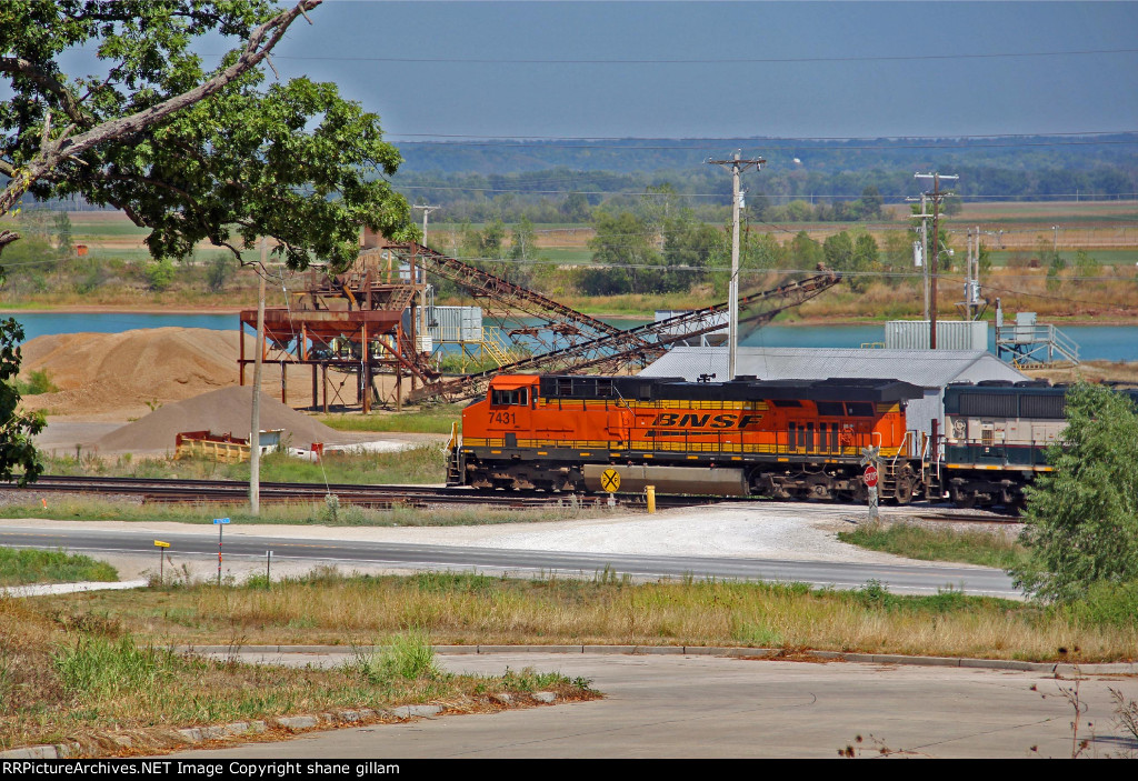 BNSF 7431 takes a loaded coal train out of the siding NB.